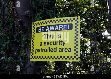 Be aware, This is a security patrolled area sign Stock Photo - Alamy
