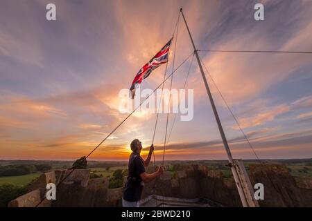 Lowering the Union Flag also known as The Union Jack at sunset, on the ...