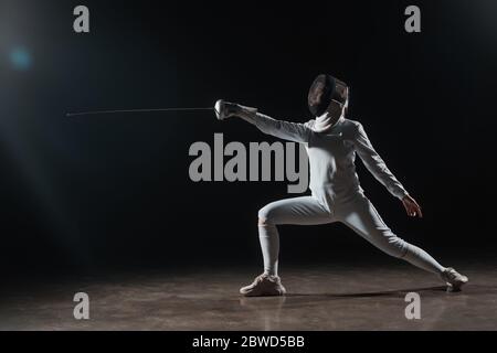 Woman in fencing lunge Stock Photo - Alamy