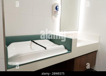 Child diaper table in a public restroom. Baby changing board by the ...