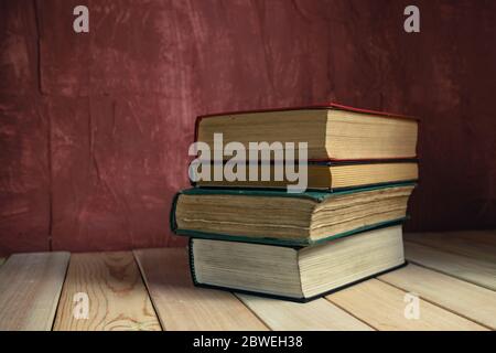 Beautiful old books on a red wooden table. Green wall background Stock ...