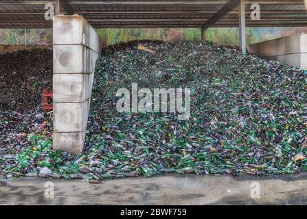 Glass waste for recycling in a recycling facility. Different glass ...