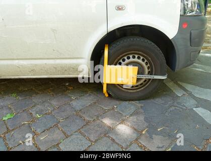 Wheel clamp, wheel boot, parking boot, or Denver boot is a device that ...