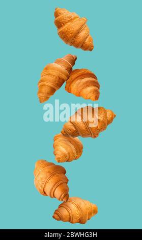 Puff pastry. Fresh croissants falling on grey background Stock Photo ...