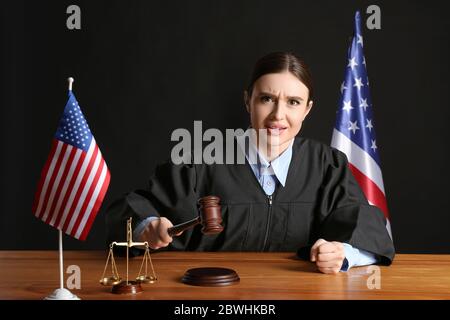 Strict female judge at table in courtroom Stock Photo - Alamy