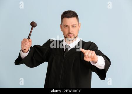 Strict male judge on light background Stock Photo - Alamy