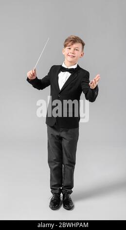 Little conductor on grey background Stock Photo - Alamy