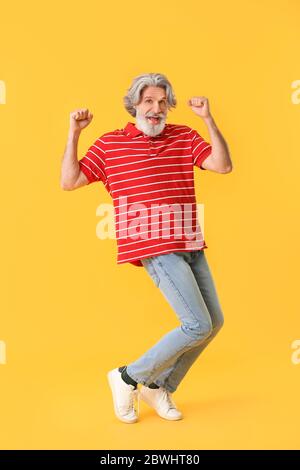 Cool senior man dancing against grey background Stock Photo - Alamy