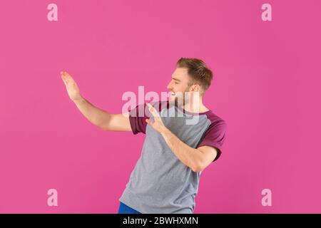 Handsome dancing man on color background Stock Photo - Alamy