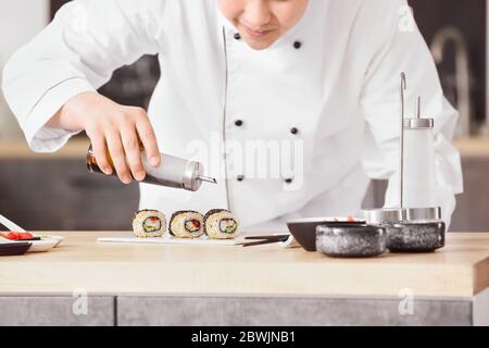 Handsome Asian chef cooking in kitchen Stock Photo - Alamy