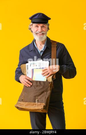 Handsome old postman on color background Stock Photo - Alamy