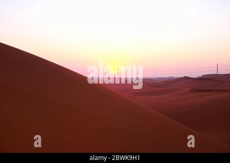 Pastel colored sunrise on the red sand dunes of the Al Dahna Desert in ...