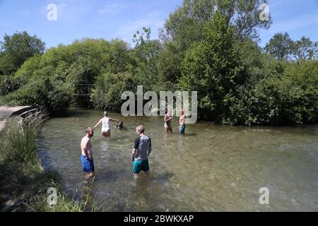 People and a dog in the water at Compton Lock on the River Itchen near ...