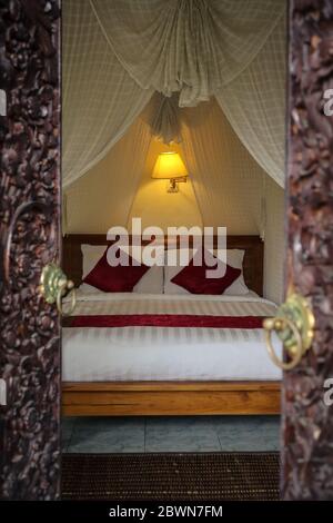 Traditional balinese cozy canopy bed in bedroom Stock Photo - Alamy
