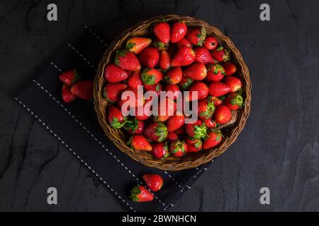 Mellow strawberries in rattan basket on tablecloth Stock Photo - Alamy