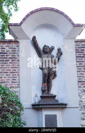 Carved stone statue of St Sebastian, martyred by being shot with arrows ...