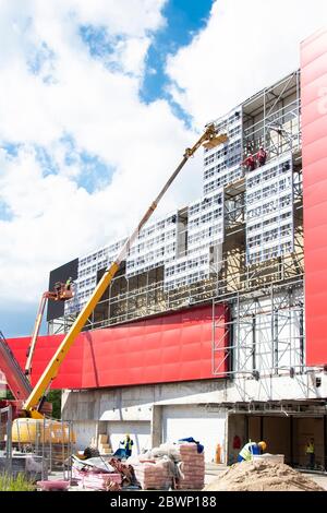 Construction site - workers wall cladding stone Stock Photo - Alamy