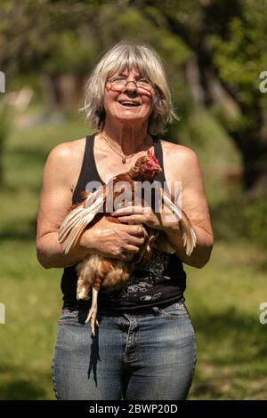 Woman with chicken in her arms Stock Photo - Alamy