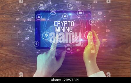 Close-up of a tablet with CRYPTO MINING inscription, innovative ...
