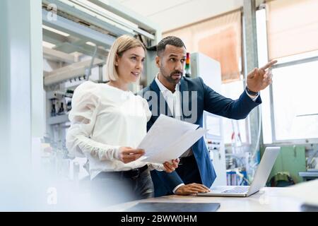 business man and woman laptop and documents on the table view from ...