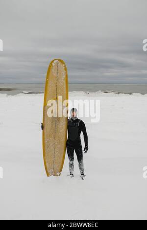 Surfer with surfboard in snow in Ontario, Canada Stock Photo - Alamy