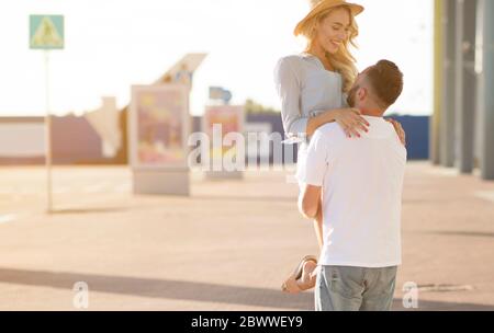 Boyfriend picking up his girlfriend near airport building Stock Photo ...