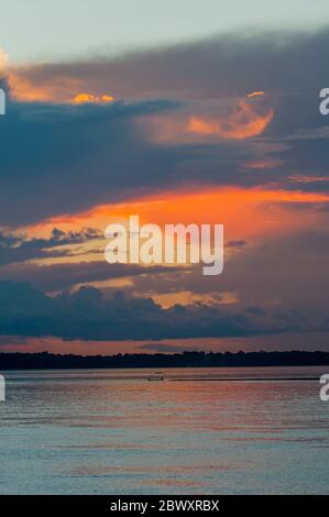 Sunset over the rain forest along the Amazon River in the Peruvian ...