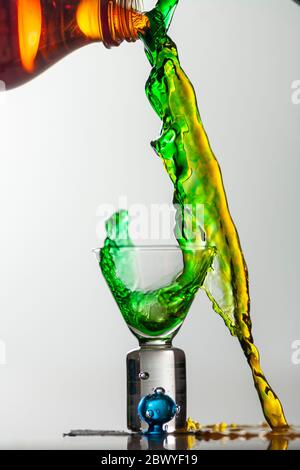 Pouring different color liquids into glasses Stock Photo - Alamy