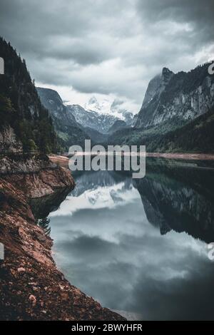Misty summer morning on the Vorderer Gosausee lake with view of ...