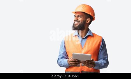 Builder uniform and digital tablet on wooden background, flat lay Stock ...