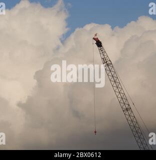 Tower Crane lattice boom hook clear blue sky sun background ...