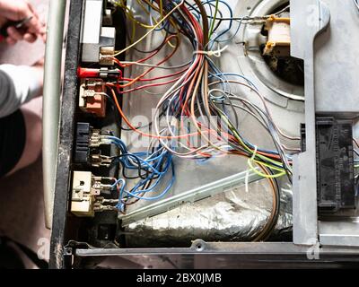 Disassembled electric oven during repair with removed electronic module ...