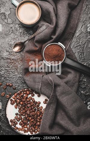 Flat lay composition with ground coffee and roasted beans on light blue ...