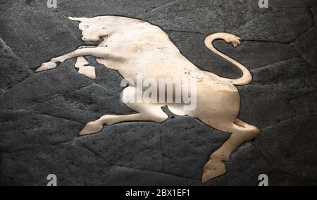 Turin city symbol - the rampant bull. In brass in the stone pavement ...