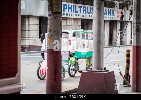 Pedestrians pass a street Vendor selling traditional hot roast ...