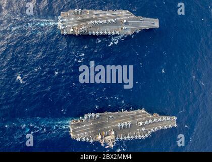 The Gerald R. Ford Carrier Strike Group sails in formation during a ...