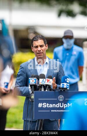 Young handsome hispanic man at political campaign election holding cuba ...