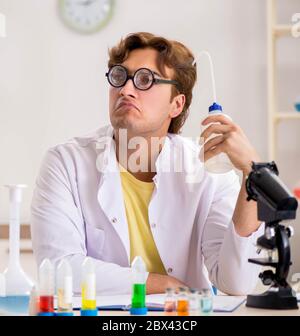 Funny crazy chemist doing experiments and tests Stock Photo - Alamy