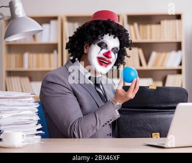 Clown businessman working in the office frustrated commiting suicide ...