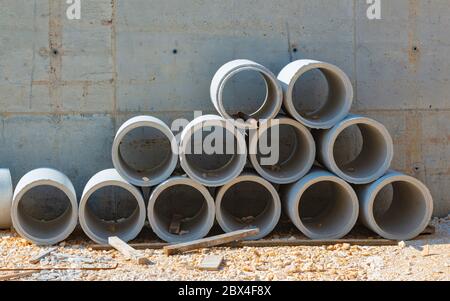 Precast Concrete Drainage pipes stacked up on construction site for new ...