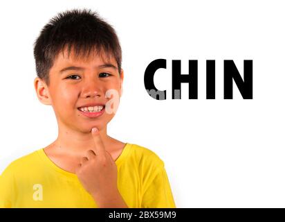 Happy Asian child pointing his chin and smiling. Portrait of young boy ...