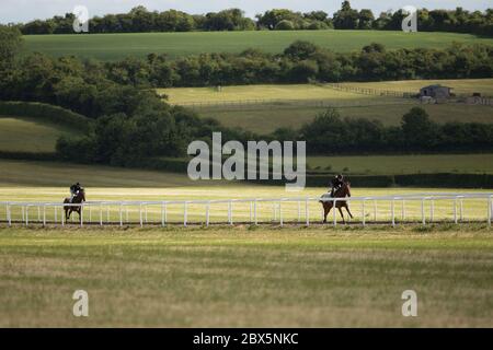 Kingsclere, Hampshire. 5th June, 2020. Riders and their horses train on ...