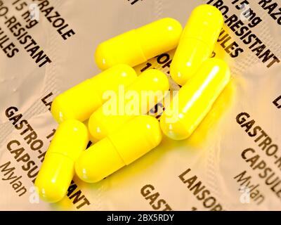 7 Lansoprazole yellow 15mg capsule pills against package background ...