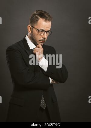 Young serious thoughtful businessman. Doubt concept Stock Photo - Alamy