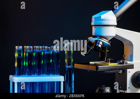 Microscope with lenses close up against dark background Stock Photo - Alamy