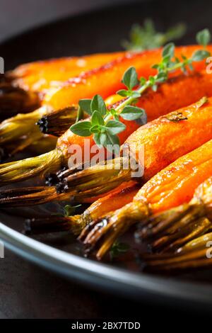 Baby carrots in dish on white Stock Photo - Alamy
