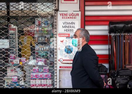 A man wears a face mask as he walks past the Old Opera in Frankfurt ...