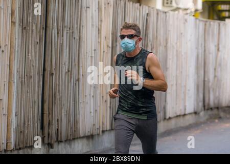 covid-19 deconfinement - young attractive and happy man outdoors in ...