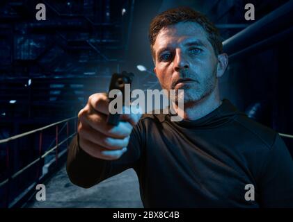 action portrait of serious and attractive hitman or special agent man ...