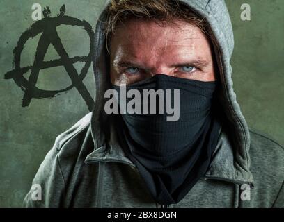 young man as ultra and radical anarchist rioter . furious antifa ...
